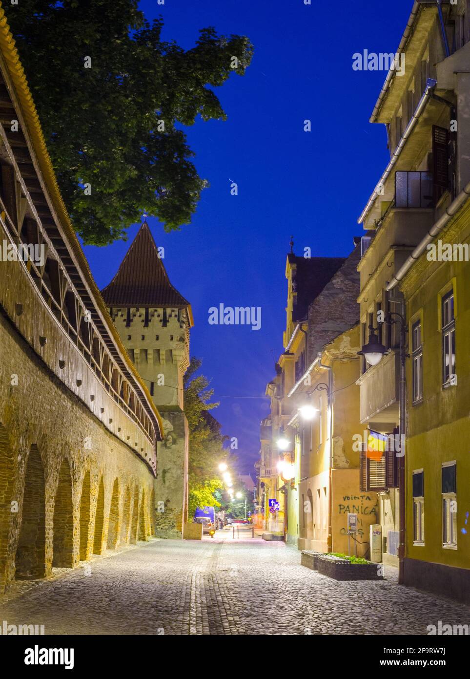 illuminated medieval defense wall and The Carpenters' Tower in Sibiu ...