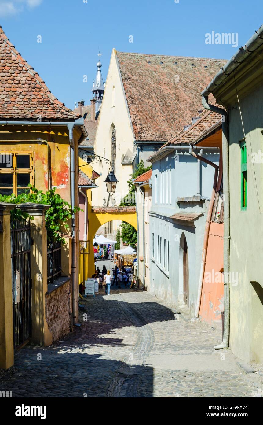 Stone paved old streets with colorful houses in Sighisoara fortress ...