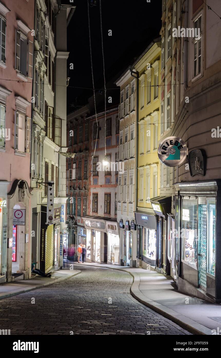 night view of an illuminated street in the historical center of Graz in ...