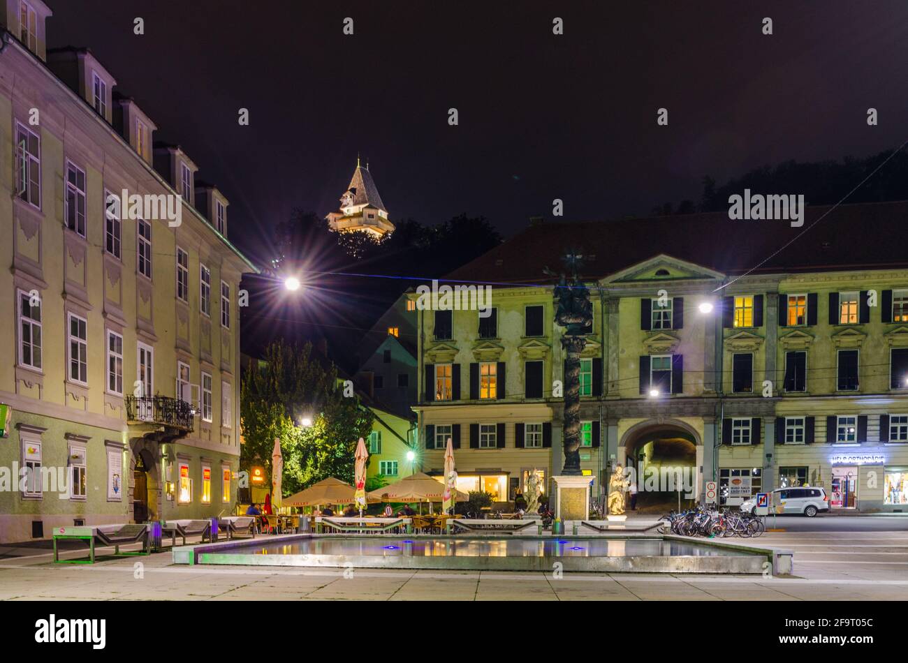 Night view of the illuminated karmeliterplatz in the austrian city graz ...