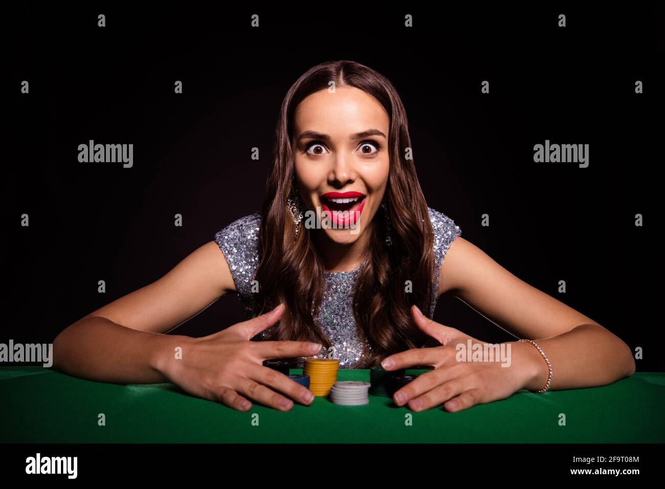 Photo of excited crazy lady sit poker table open mouth grab chips wear ...