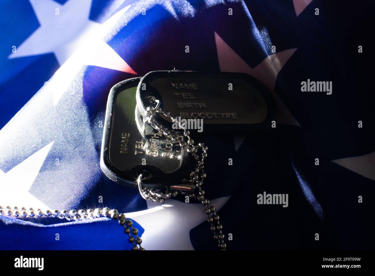 Army tokens on American national flag background Stock Photo - Alamy