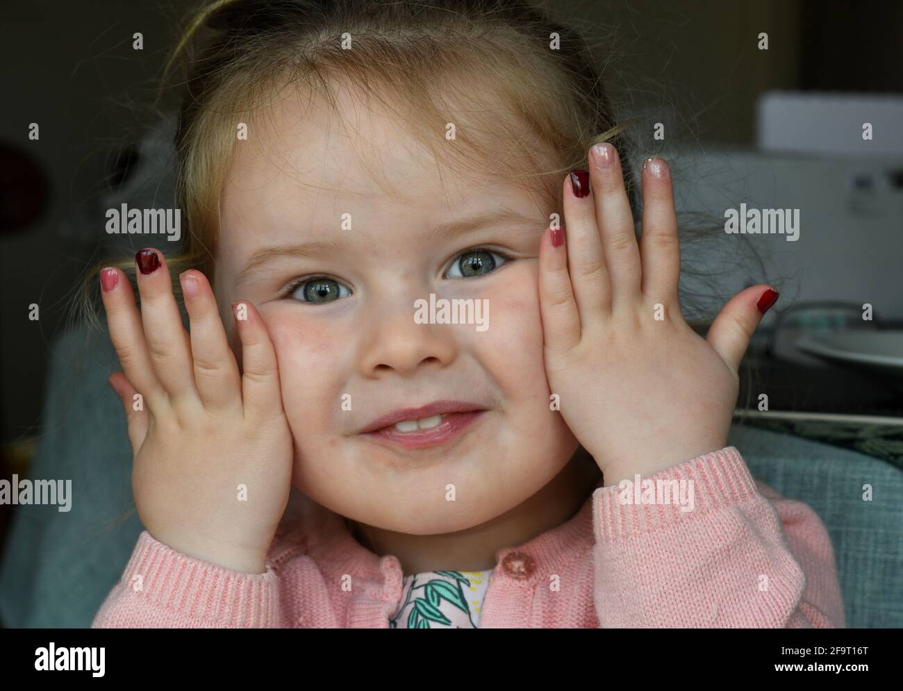 Happy smiling child girl wearing nail varnish Stock Photo - Alamy