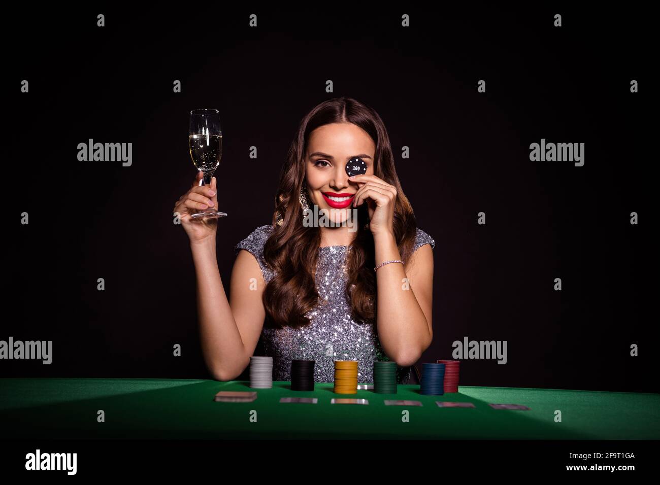 Photo of lady sit poker table hold glass champagne chip cover eye wear ...