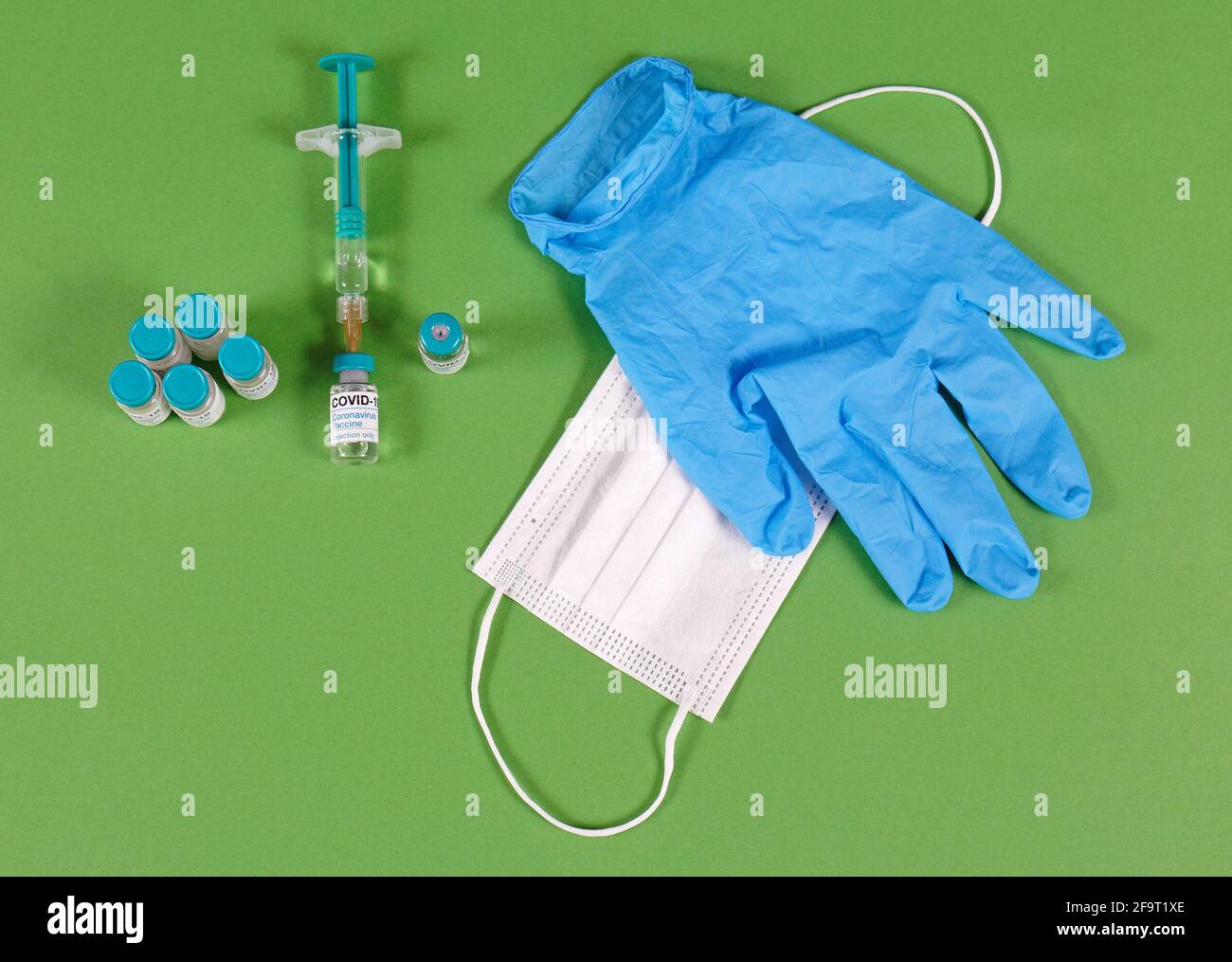 Covid-19 vaccine with syringe ready to implement face mask and latex ...