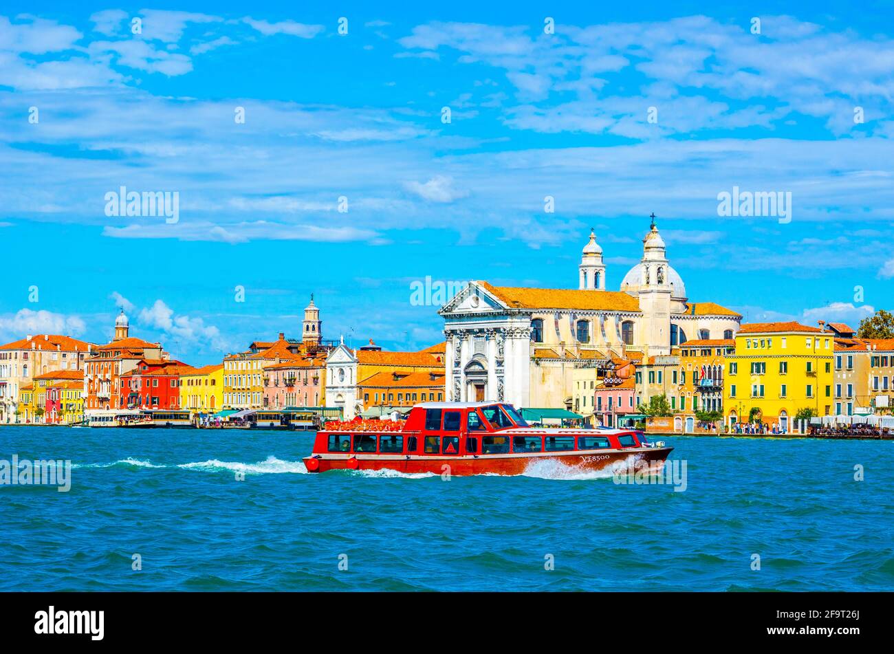 a tourist boat is passing in front of the Church Il Gesuati or Church ...