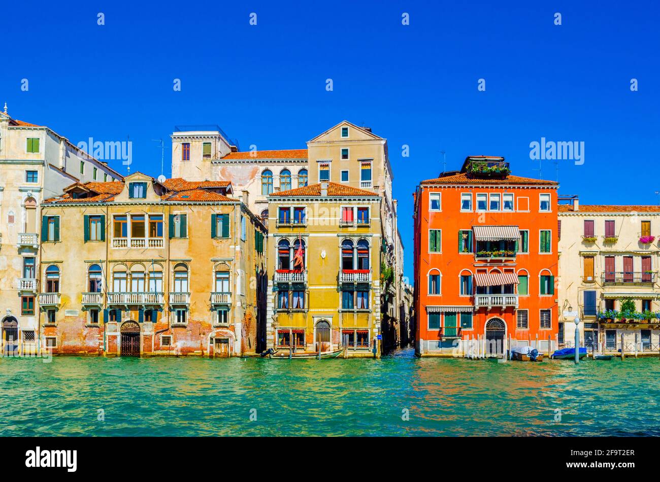 View of a colorful houses situated alongside the grand canal in italian ...