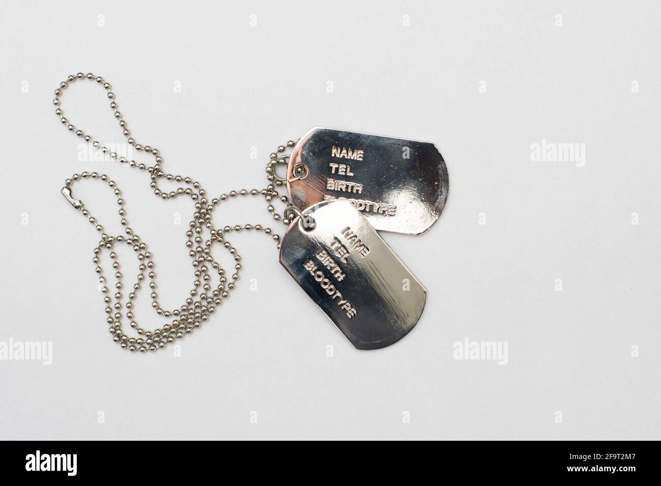 Shiny Blank Metallic Military Identification Plate on White Background Stock Photo - Alamy