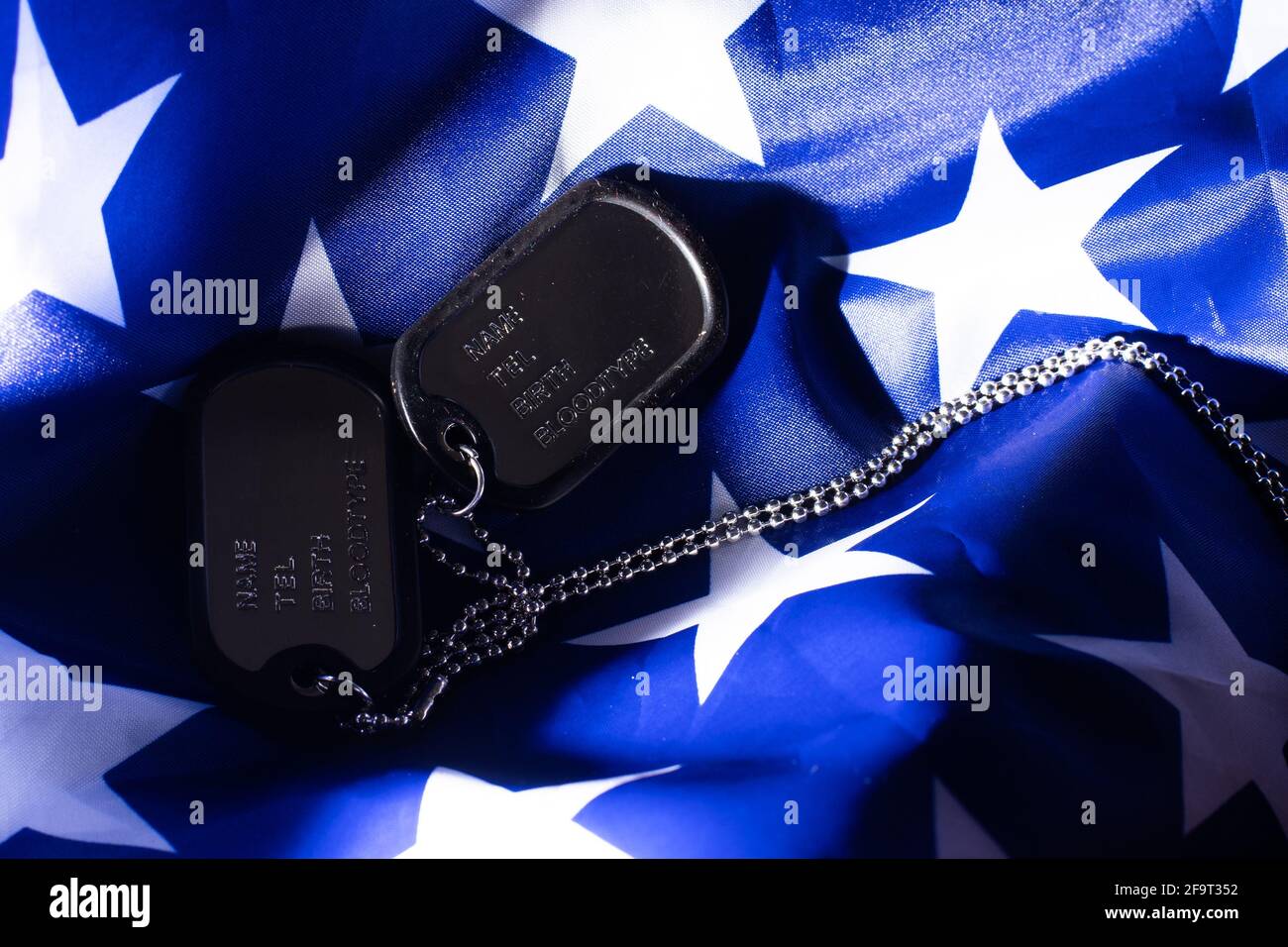 Army tokens on American national flag background Stock Photo - Alamy