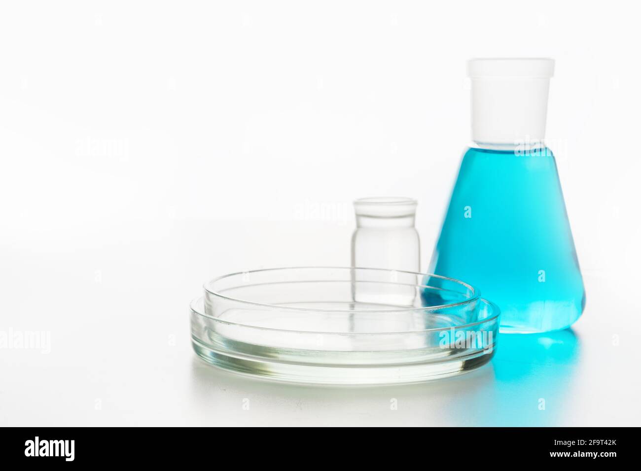 Chemistry glassware with blue liquid for science research and ...