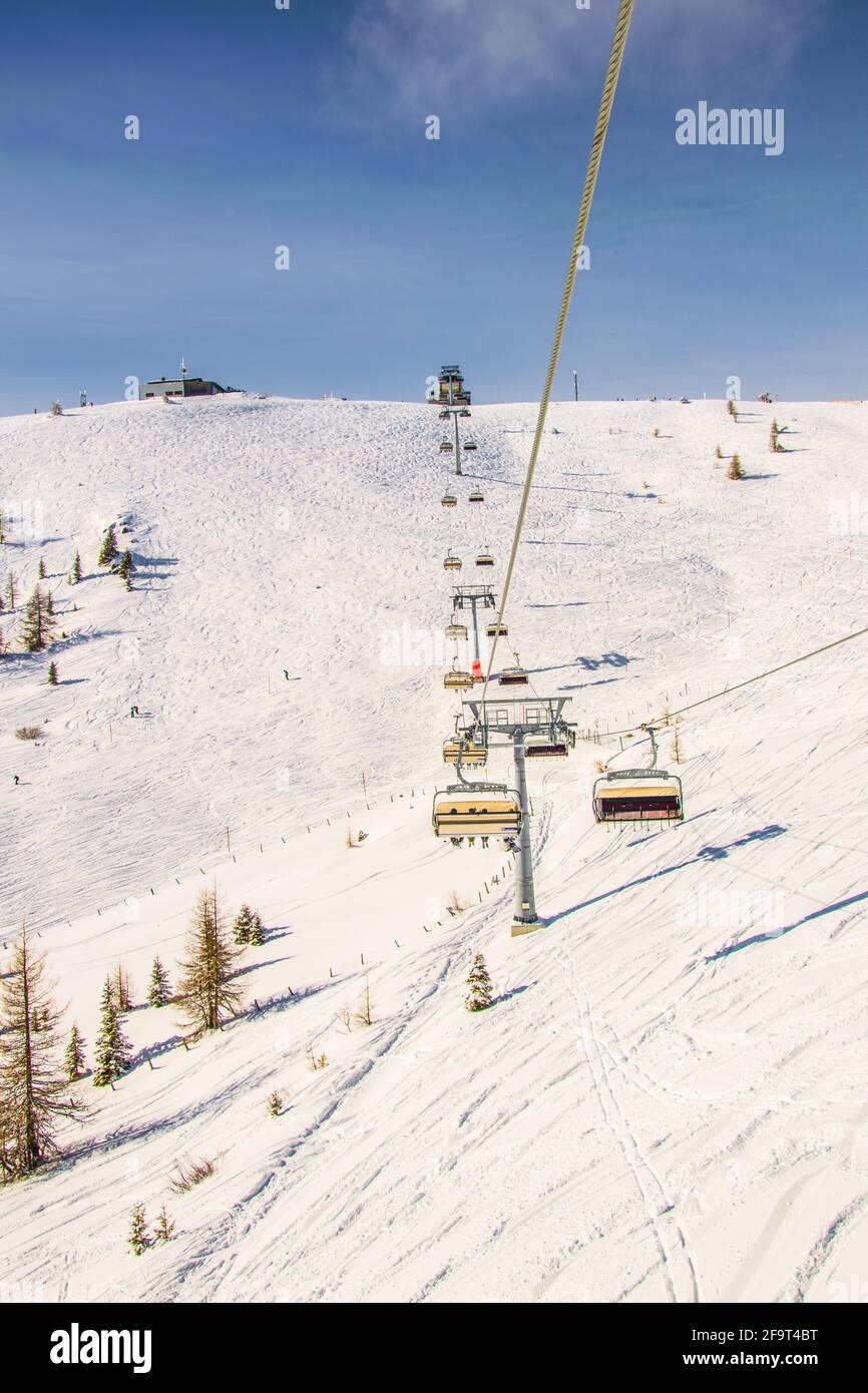 A lift is bringing skiers to top of the gerlitzen mountain in austria ...