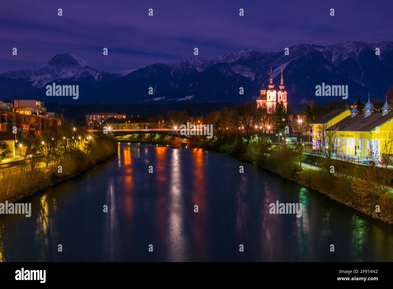 view of a riverside of river Drau during night in Villach, Austria ...