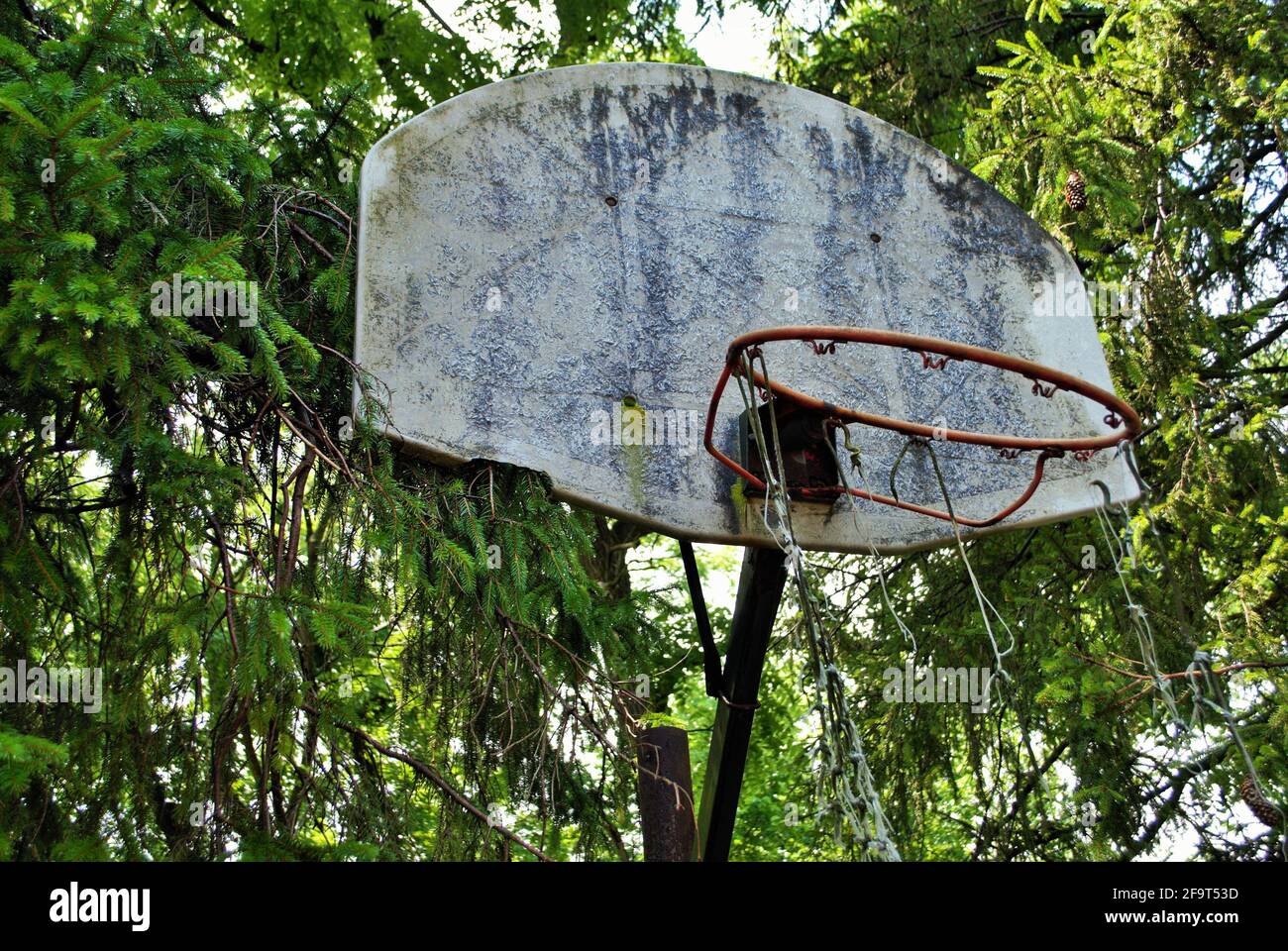 very old abandoned basketball hoop that is falling apart Stock Photo ...