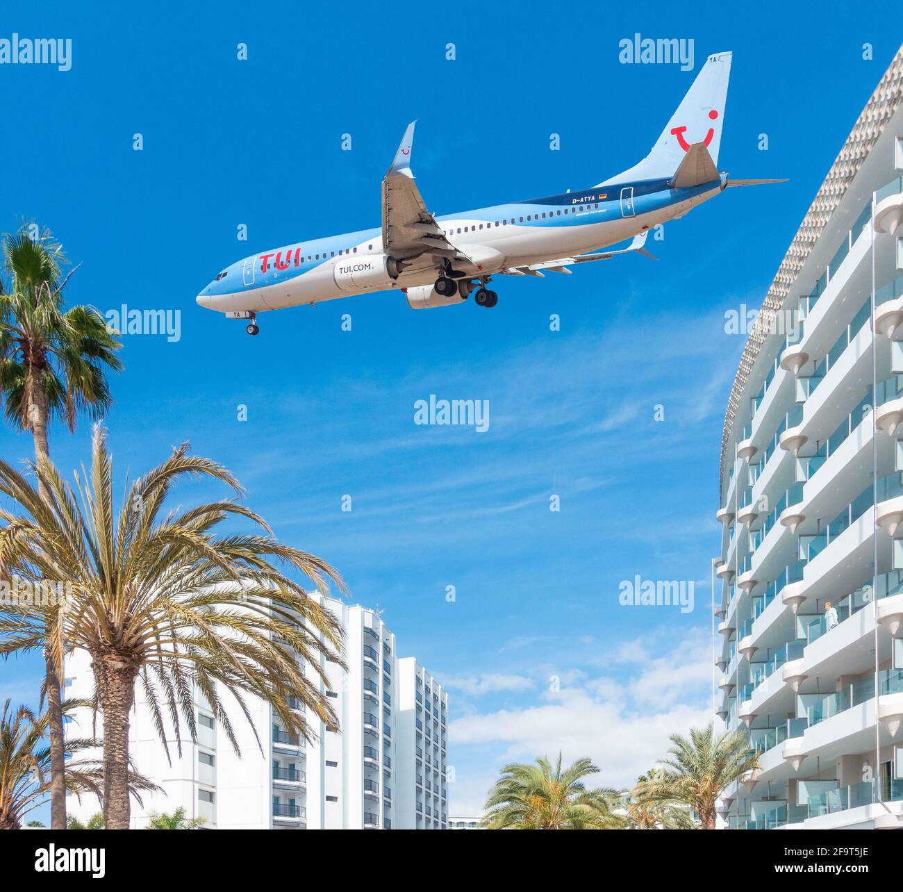 TUI airplane, aircraft flying over hotel in Spain. Composite image ...