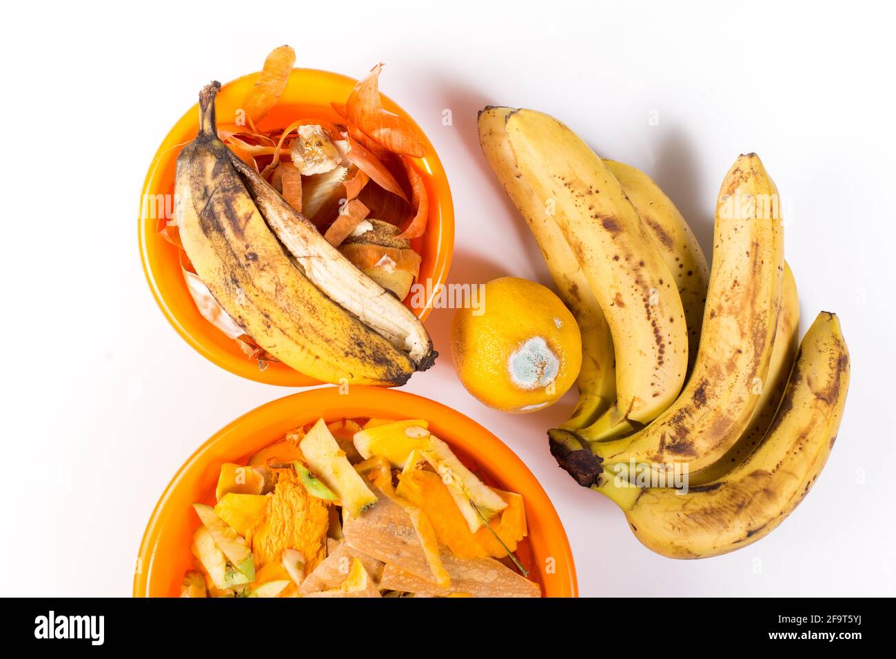 Using spoiled fruits and other organic kitchen waste in bowls, on white ...