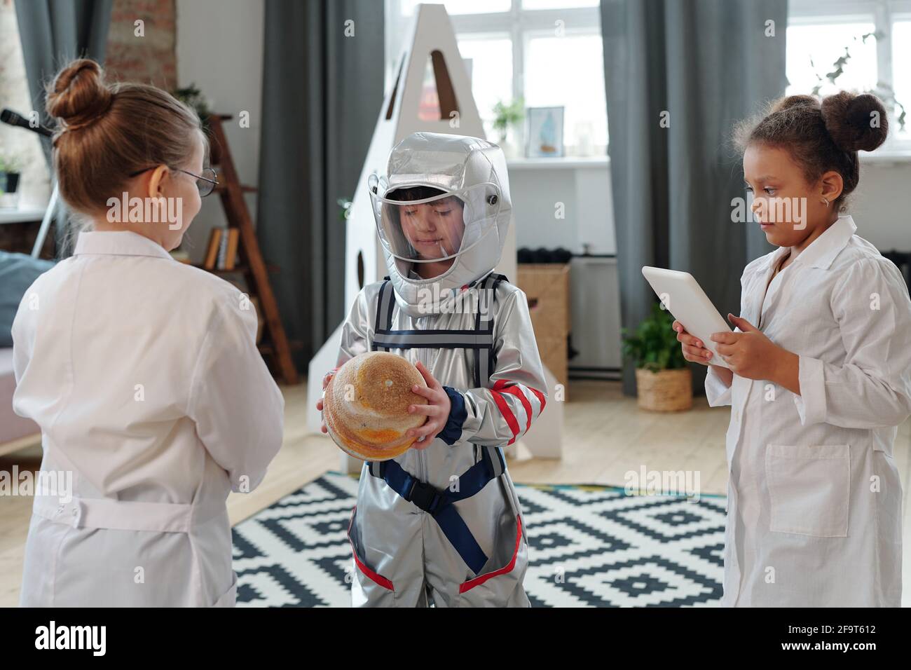 Group of children in costumes performing a play they playing astronauts ...