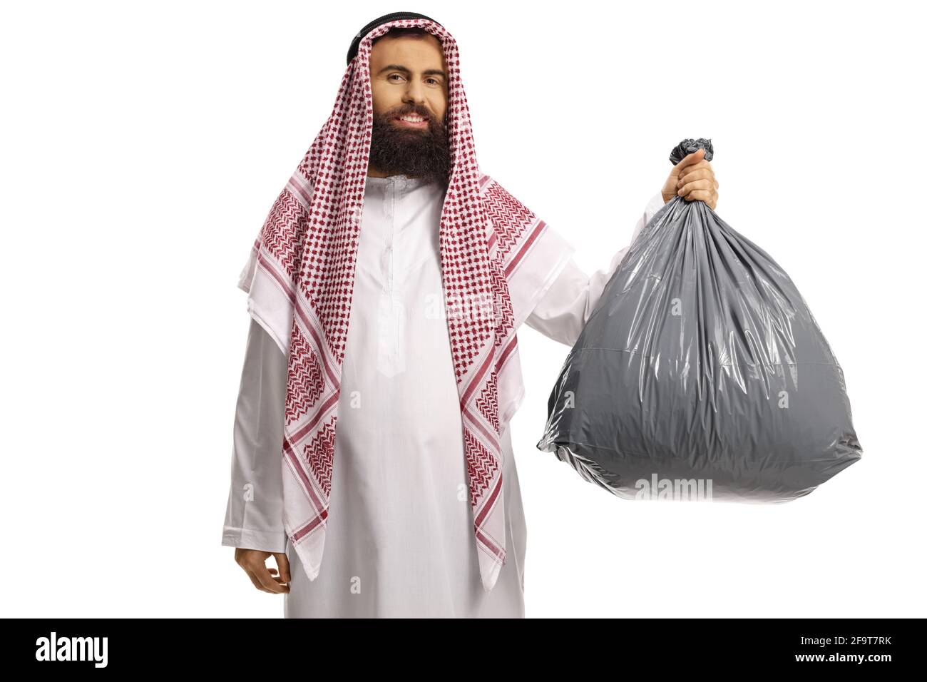 Young saudi arab man holding a plastic waste bag isolated on white ...
