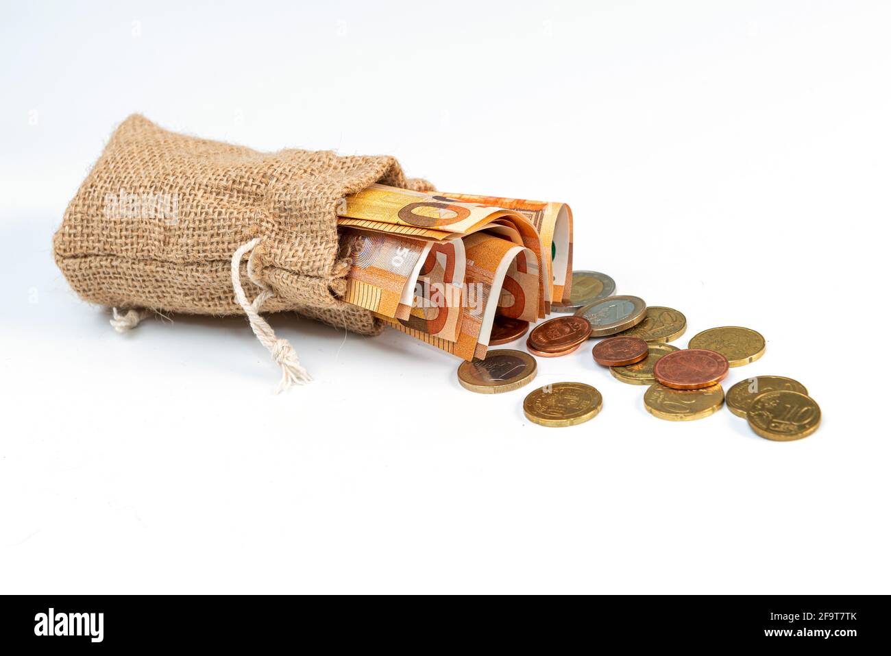 cloth bag filled with rolled euro banknotes and coins, isolated on ...