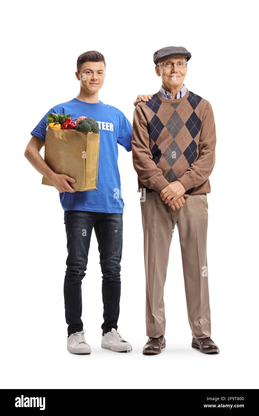 Young male volunteer helping an elderly man with grocery shopping ...