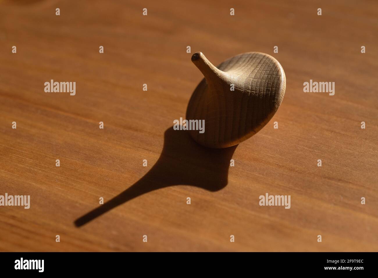 closeup of a spinning top symbolizing a fragile, unstable condition of ...