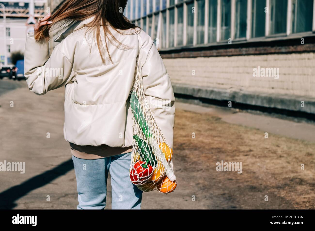 Reusable recyclable lifestyle concept. YClose up young woman walks ...
