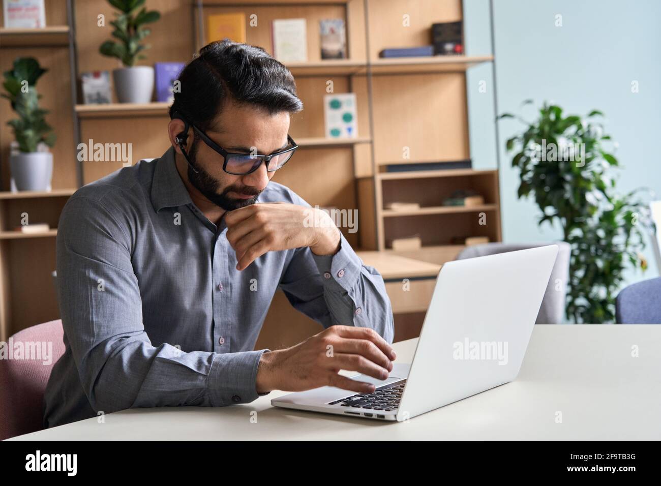 Serious indian businessman having video call with diverse people on ...