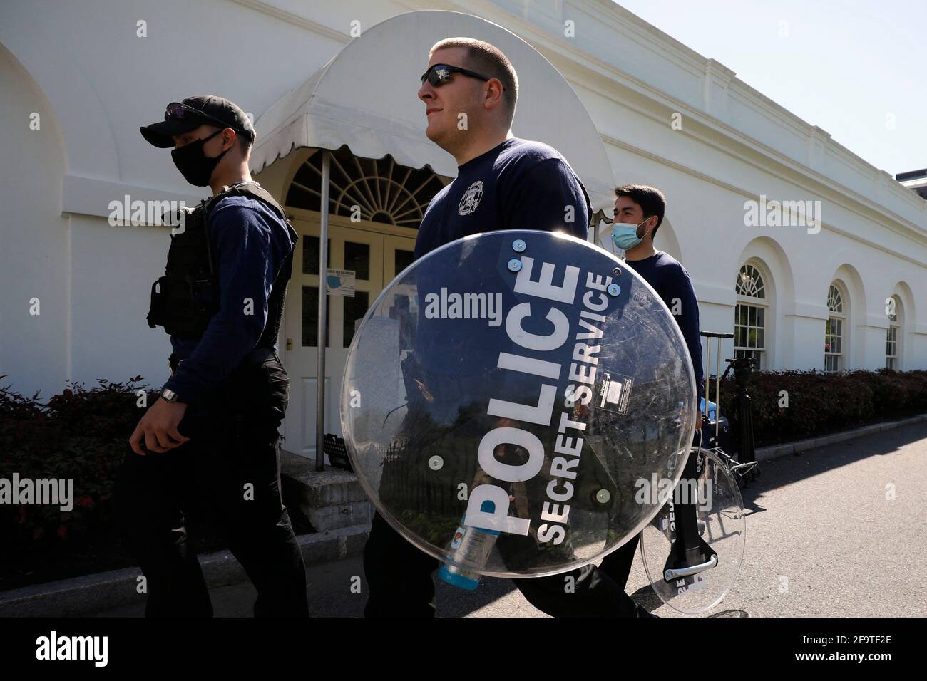Members of U.S. Secret Service carry riot shields on a driveway at the ...