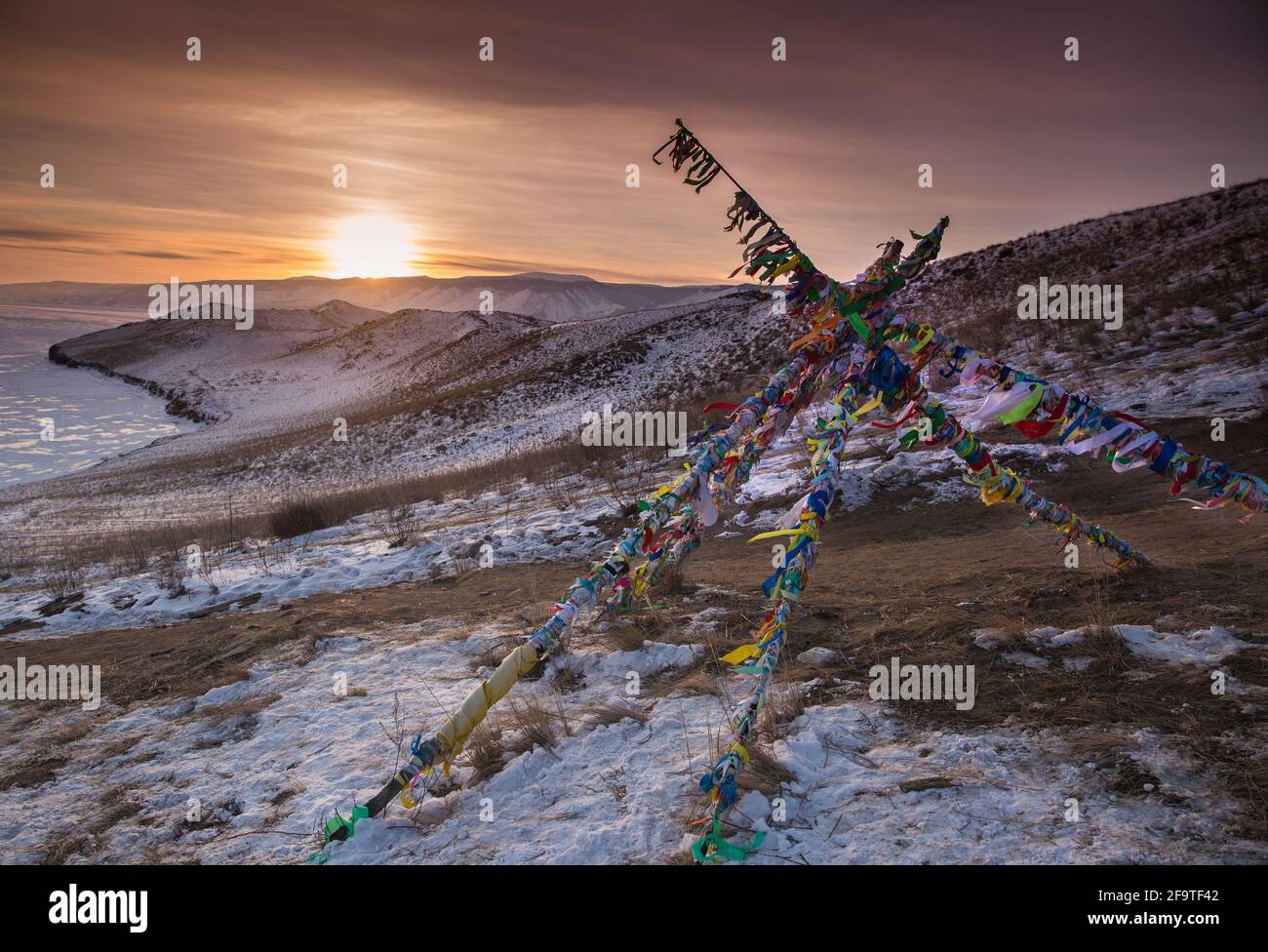 Colored ritual ribbons tied on the tree and wooden poles as a buddhist ...