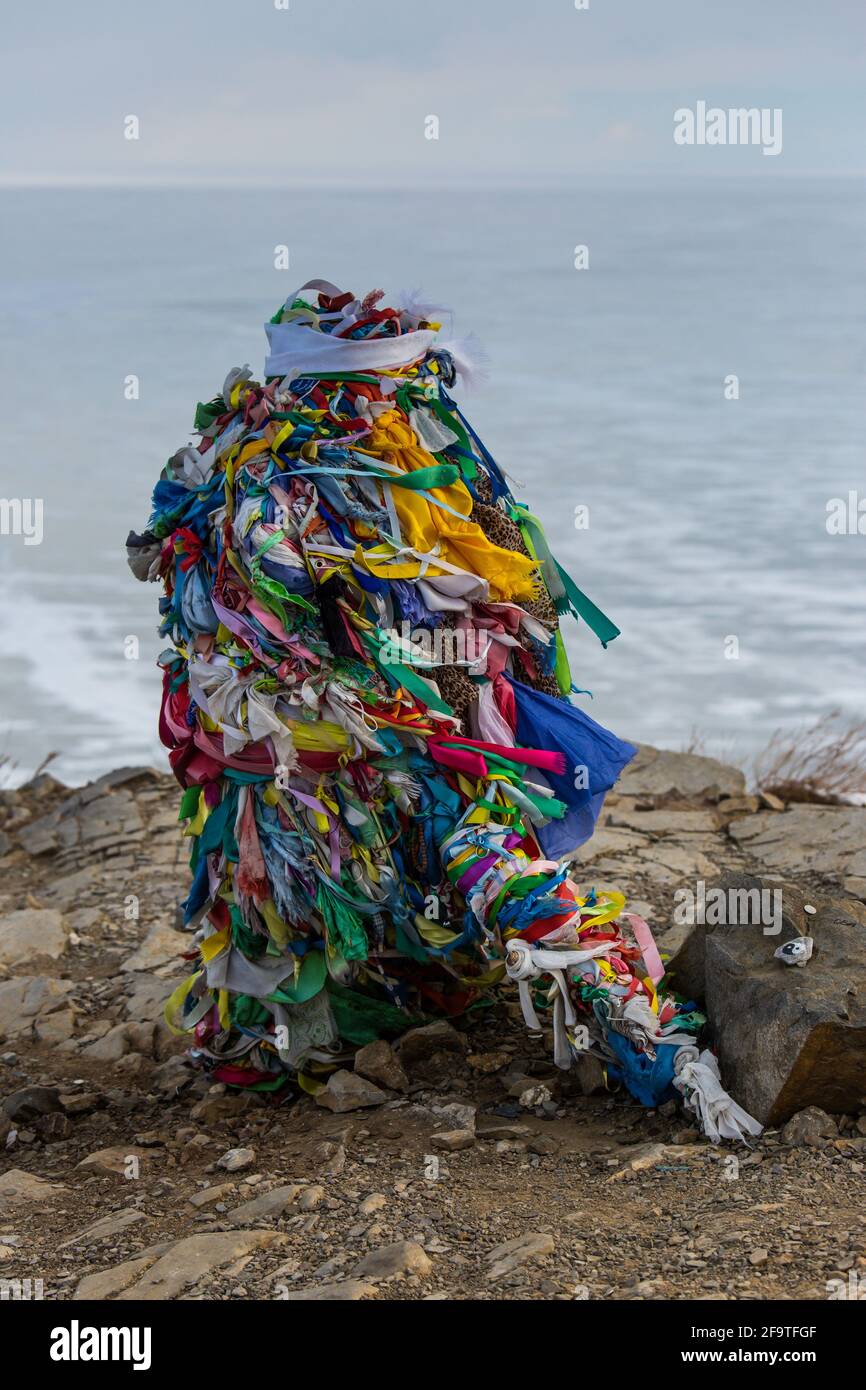 Colored ritual ribbons tied on the tree and wooden poles as a buddhist ...