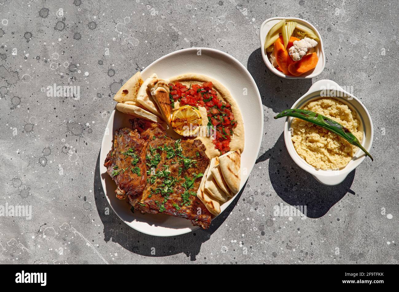 Delicious rack of lamb with hummus sauce, Traditional Arabic, Turkish ...