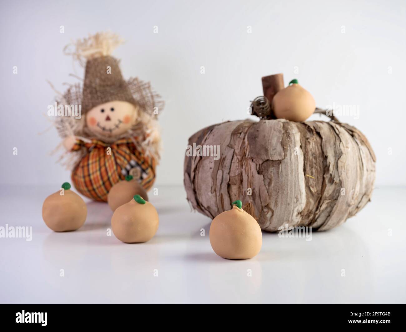 Isolated shot of stale and artificial pumpkins with scary snowman on a ...