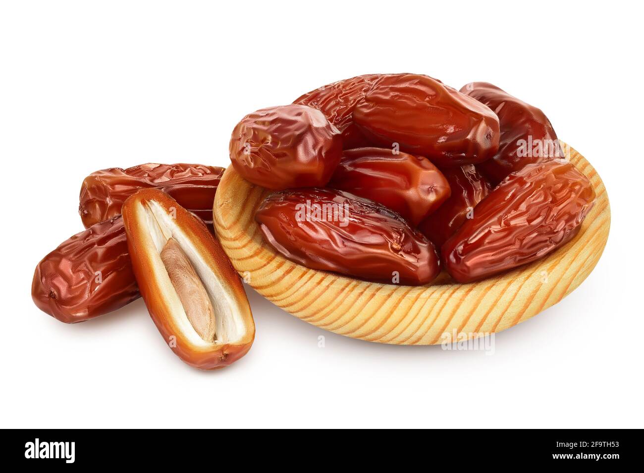 Dates in wooden bowl isolated on white background with clipping path ...