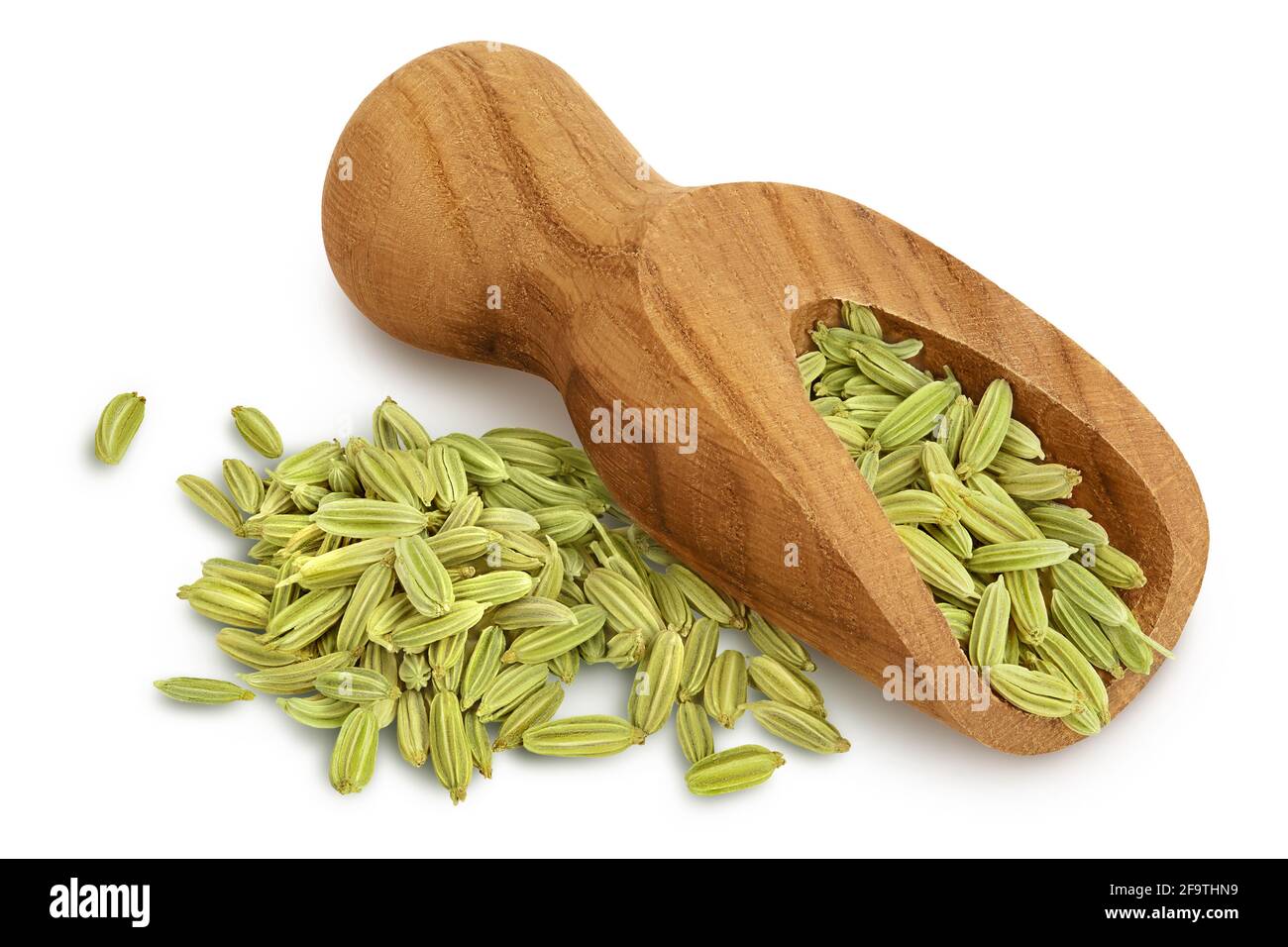 Dried fennel seeds in wooden scoop isolated on white background with ...