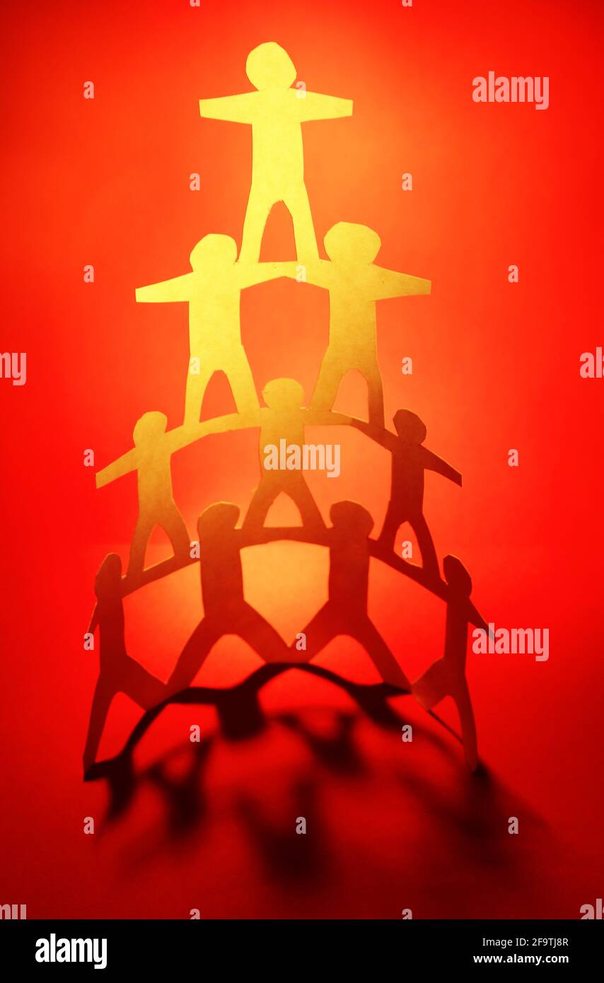 Human team pyramid supporting each other Stock Photo - Alamy