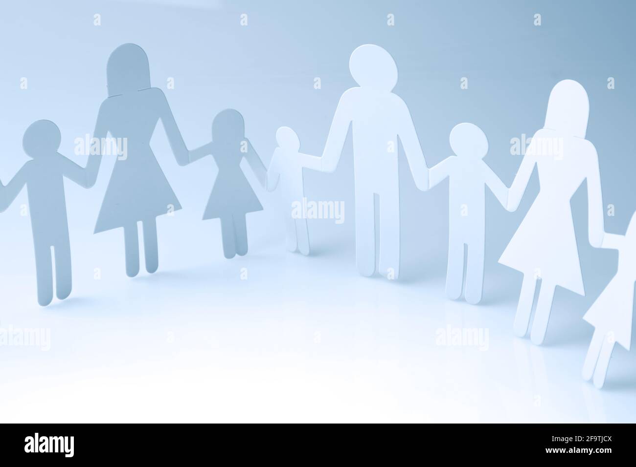 Family paper chain cutout holding hands Stock Photo - Alamy