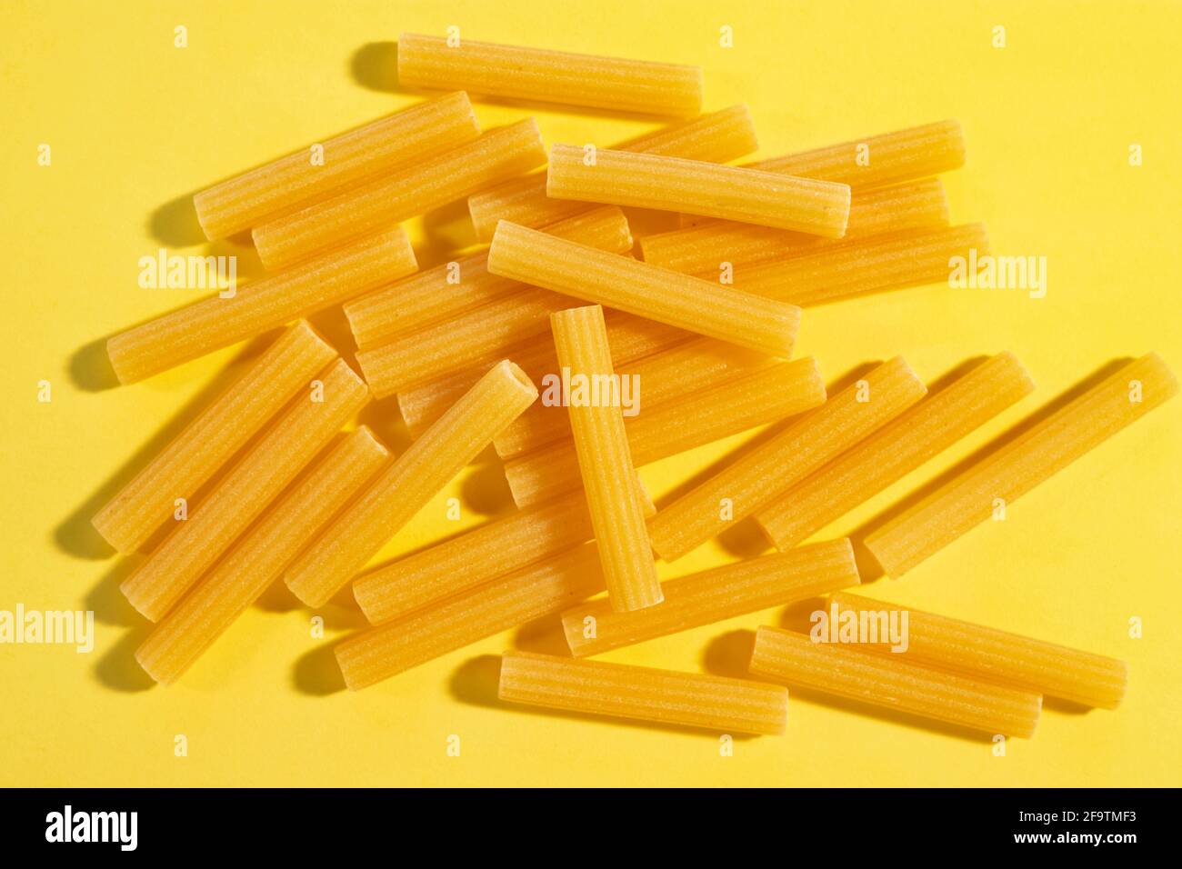 Dry pasta called maccheroni or maccaroni shaped like narrow tubes on ...