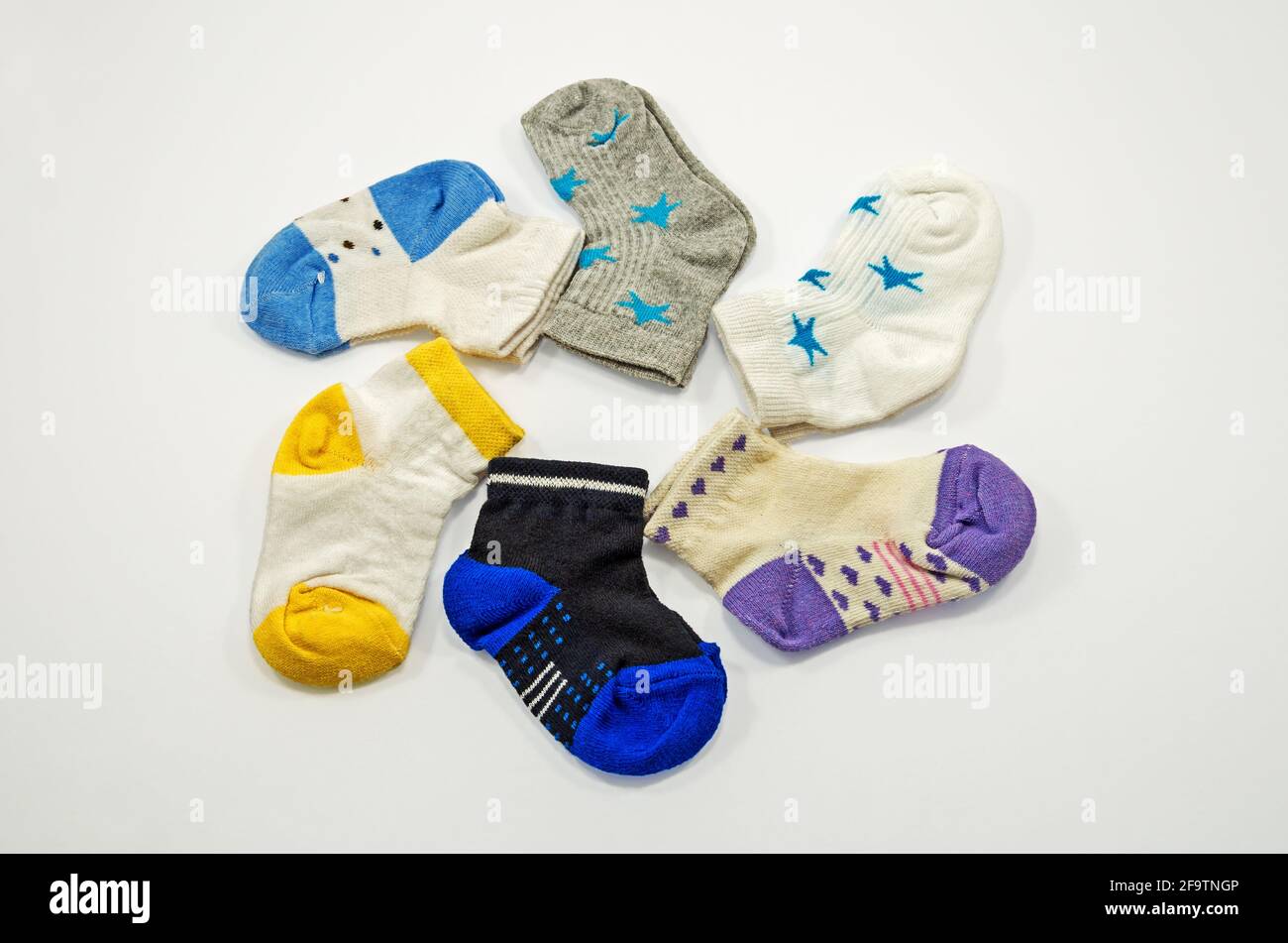 Set of colorful childrens socks folded in form of multicolor propeller ...