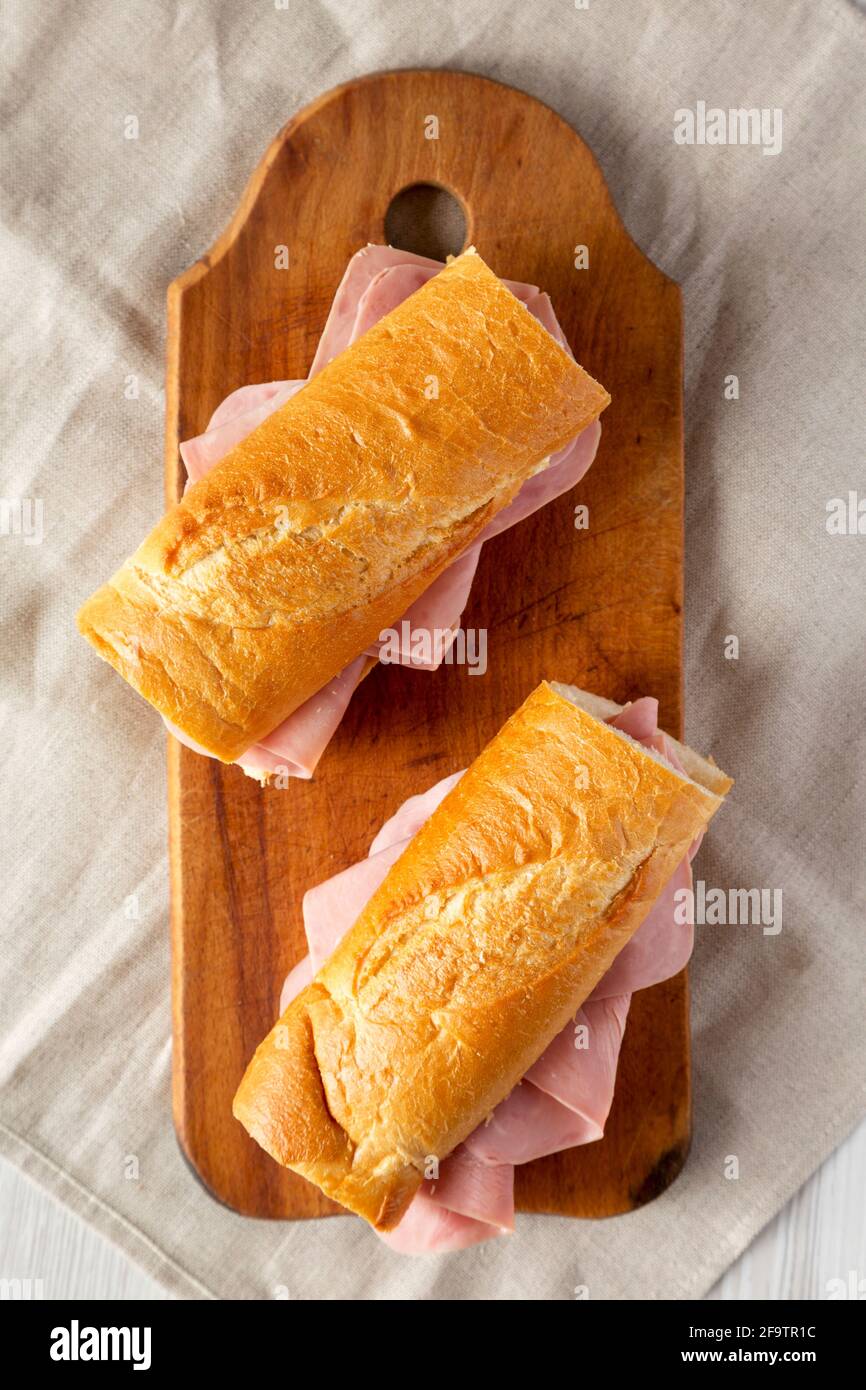 Homemade Parisian Jambon-Beurre Sandwich on a rustic wooden board , top ...