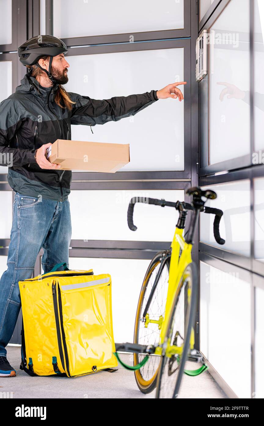 Home delivery service by courier. With cardboard box Stock Photo - Alamy