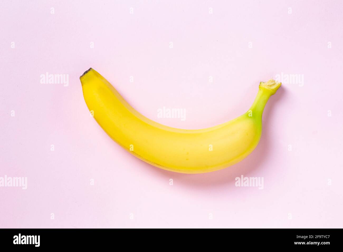 Single banana on pink background Stock Photo - Alamy