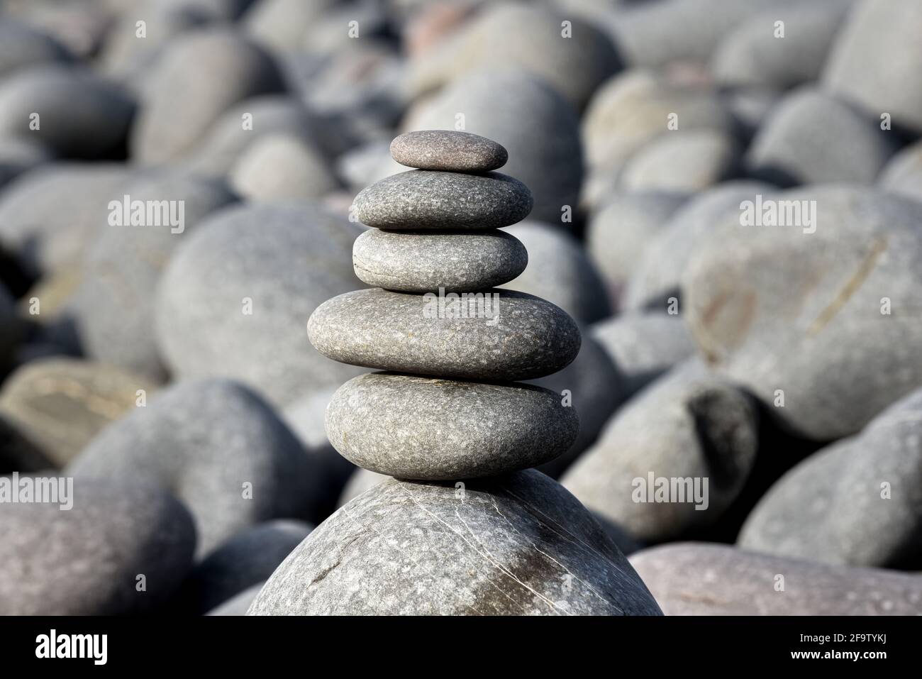 Pebble stack on the beach the stones represent balance and wellbeing of ...