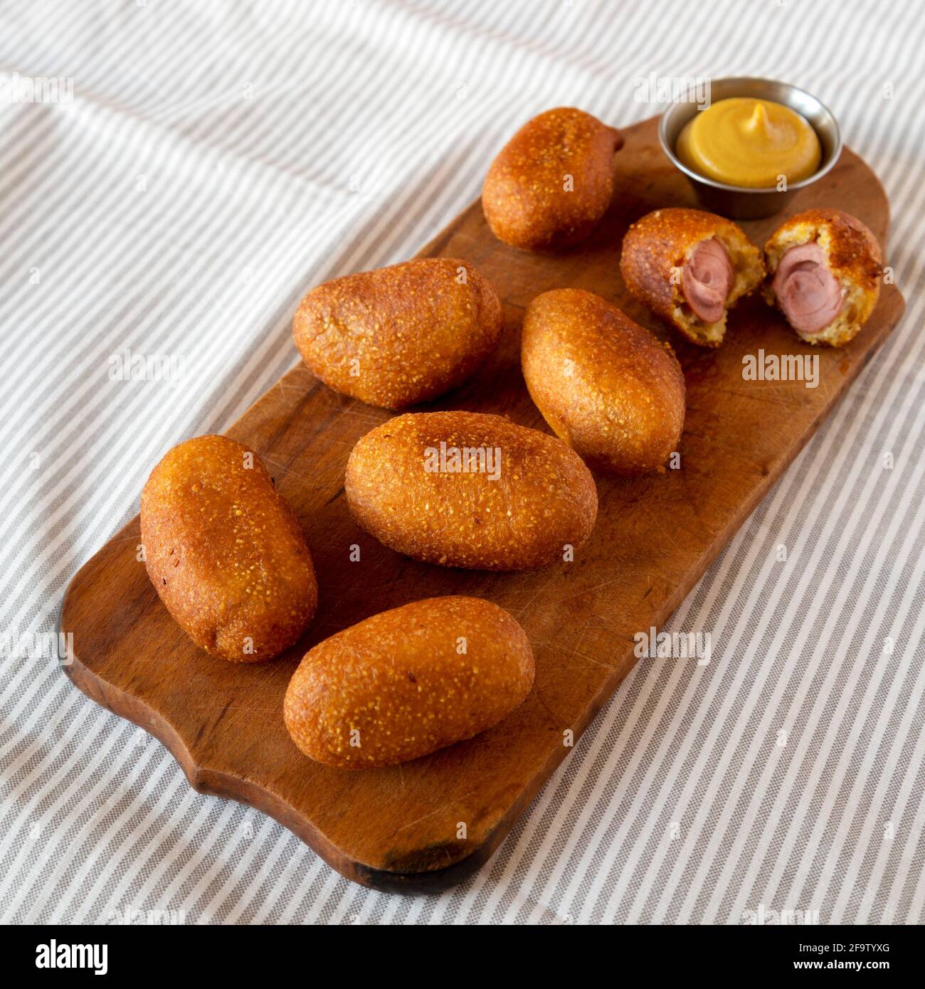 Homemade Mini Corn Dogs on a rustic wooden board, side view Stock Photo ...