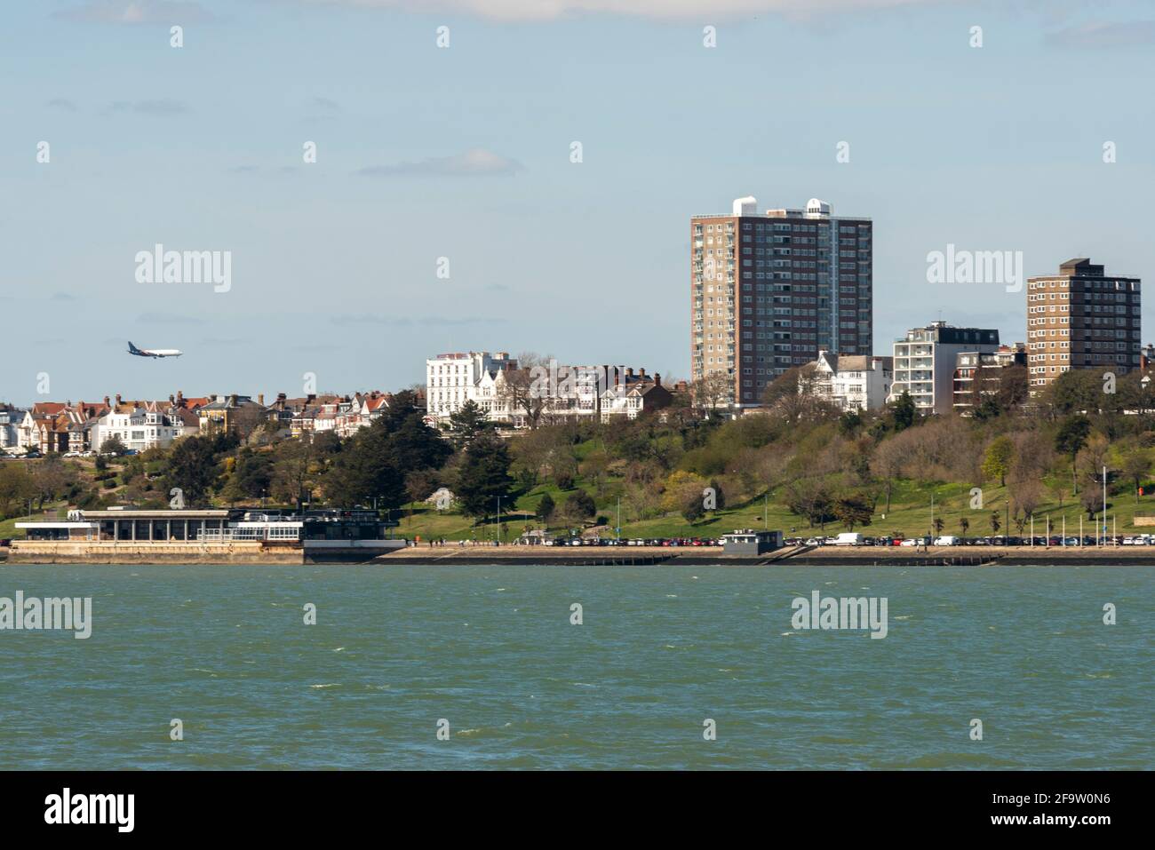 Jet airliner plane landing at London Southend Airport behind buildings ...