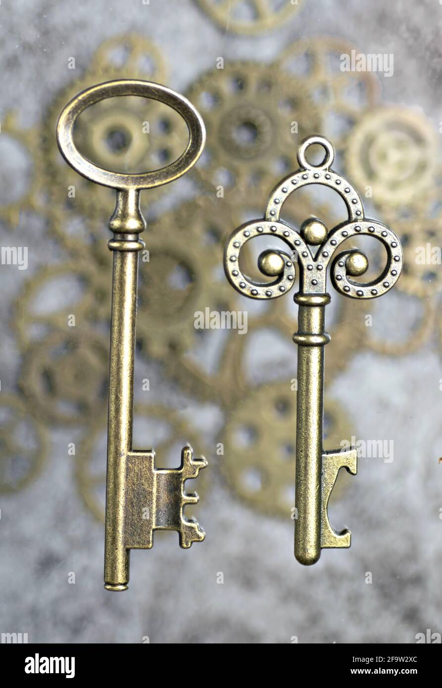 Vintage gold keys with gears in the background Stock Photo - Alamy