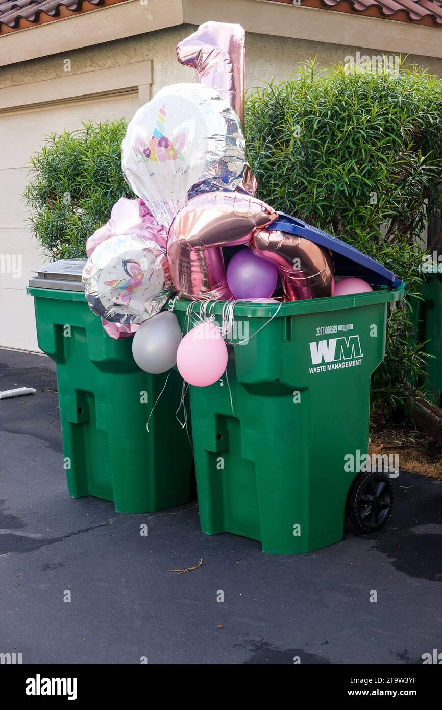 Various types of balloons in a trashcan Stock Photo - Alamy