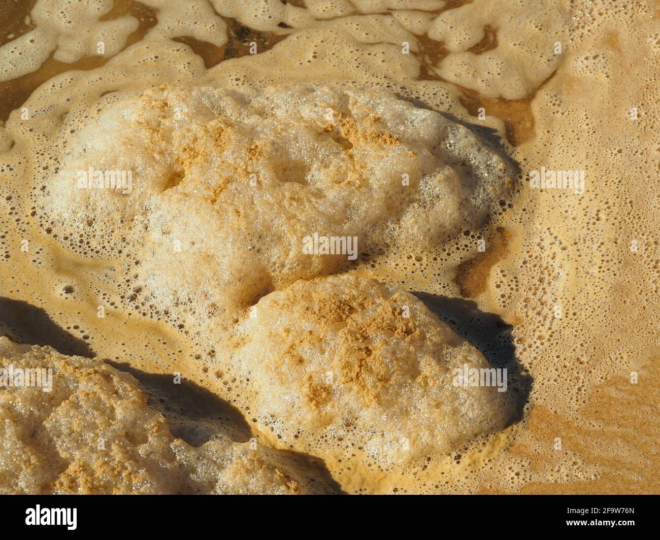 Swirling frothy foamy sea water in the rock pools Stock Photo - Alamy