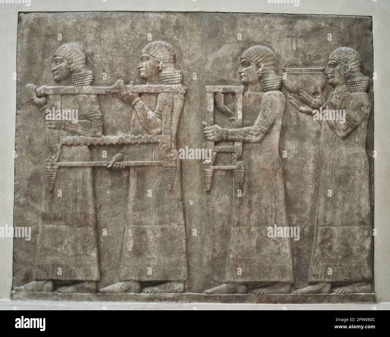Human figures relief. Mesopotamian art. Louvre Museum Stock Photo - Alamy