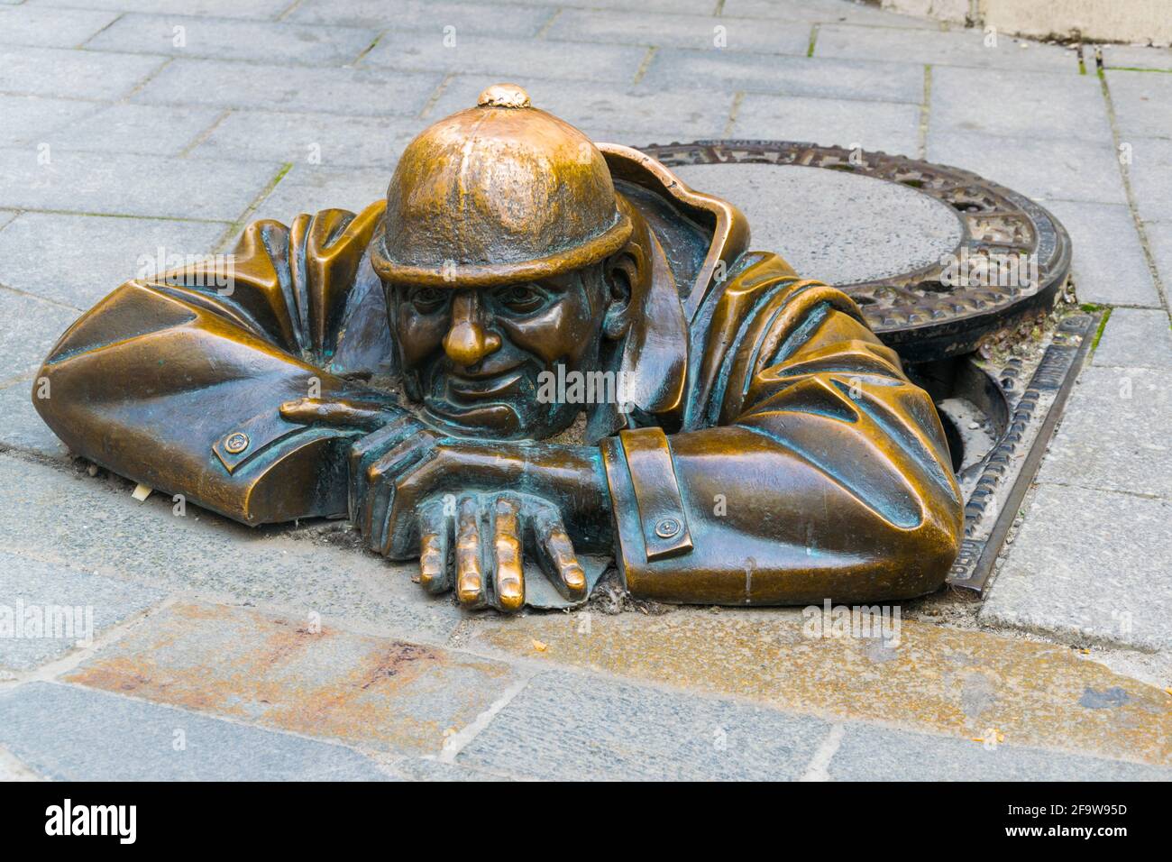 Man peeking out from under a manhole cover hi-res stock photography and ...