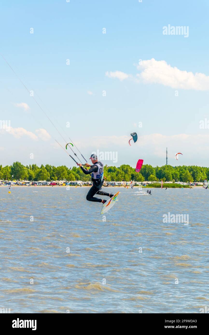 PODERSDORF, AUSTRIA, JULY 9, 2016: Young people are kite surfing on the neusiedlersee lake in ...