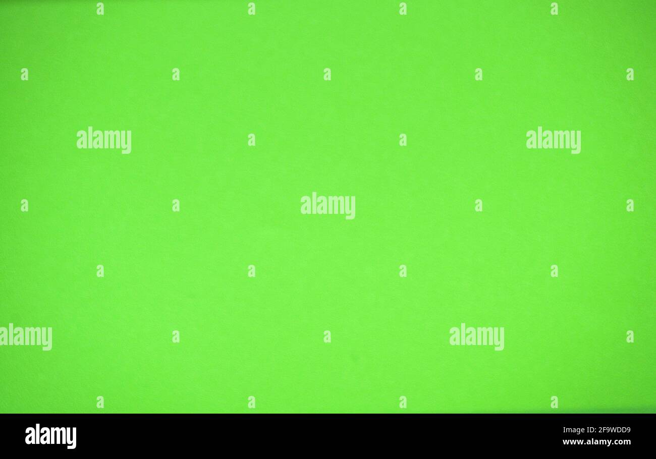 Acid green monochrome surface with rough texture and close-up ...